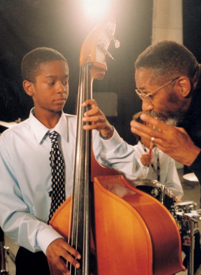 Bassist Ron Carter explains a concept to a young Ben Williams, later a ...