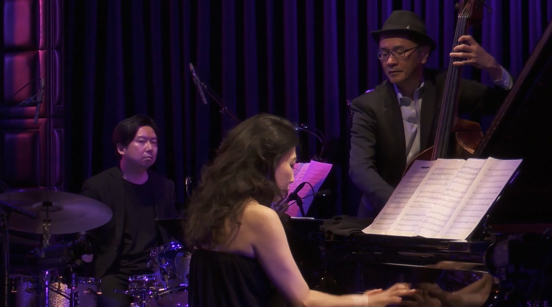 Junko Onishi (center) performs with drummer Sota Kira and bassist ...